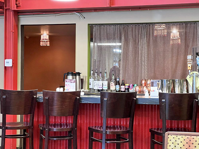 Every great neighborhood spot needs a bar that feels like it's been waiting just for you. Red accents say "stay awhile" in universal design language.
