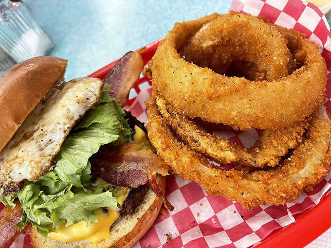 Hold onto your napkins, folks! This burger and onion ring combo is a tower of temptation that'll make your cardiologist weep.