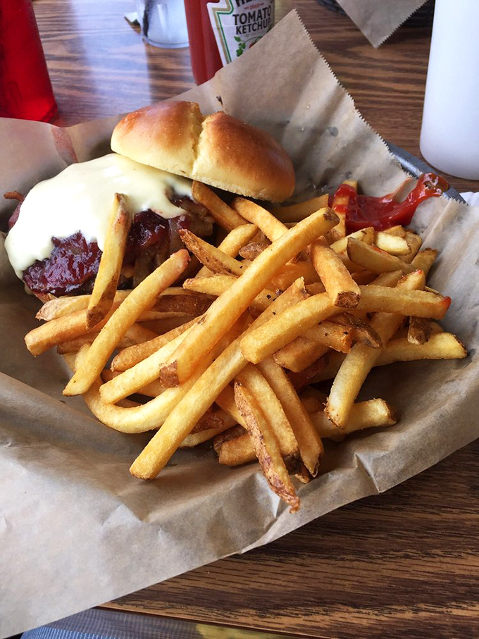 The Cranberry Brie Burger: Where fancy cheese meets down-home cooking. It's like a culinary hug from a cowboy who spent a semester abroad in Paris.