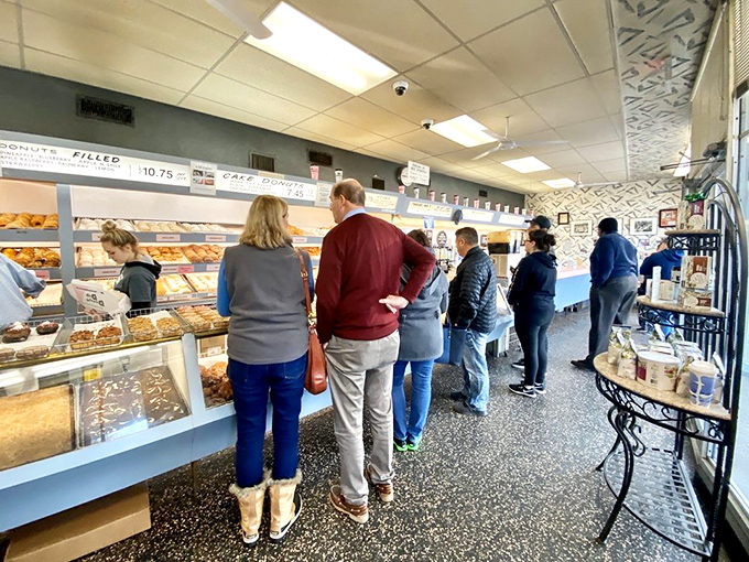 The line of anticipation! These patient customers know that good things come to those who wait &ndash; especially when those good things are freshly made donuts.
