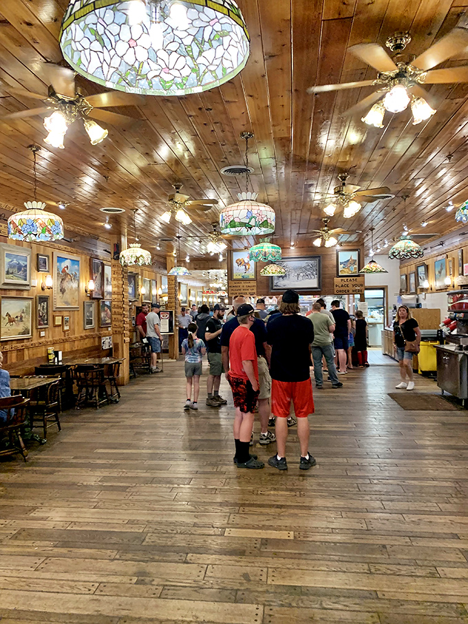 It's like a scene from "Where's Waldo?: Roadside Attraction Edition." Spot the fanny packs, the "I can't believe we're here" grins, and the inevitable "which way to the jackalope?" confusion.