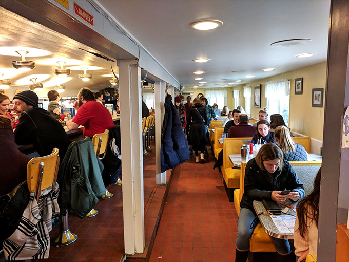 People-watching paradise! From solo diners lost in thought to animated conversations, this bustling scene is a slice of Americana in action.