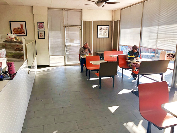 Happiness is... sharing donuts with good company. These lucky diners are living their best lives, one bite at a time.
