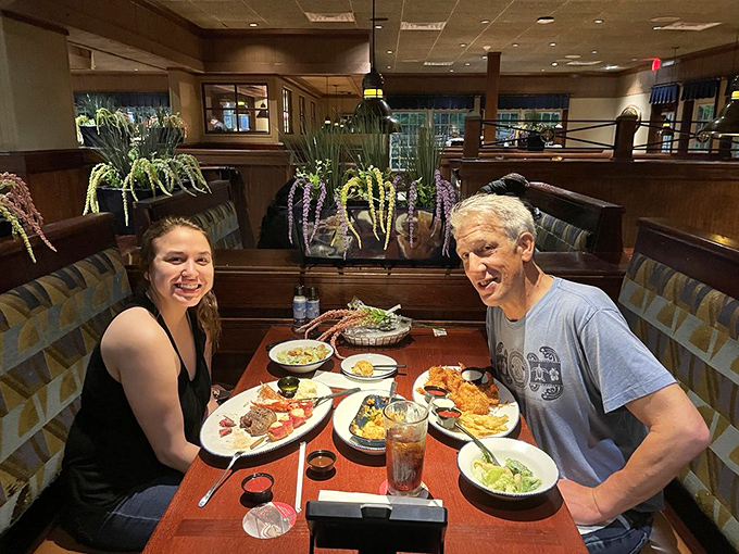 Happy diners, full bellies! This booth is like a front-row seat to the "Great Seafood Symphony" - and everyone's playing their part perfectly.