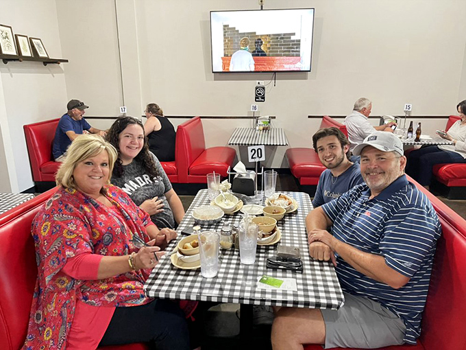 Happy diners, empty plates - the universal language of a great pizza joint. These folks look like they've found their cheesy nirvana.