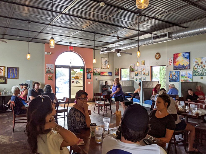 Happy diners, colorful art, and the buzz of conversation. This isn't just a cafe; it's a community hub where friendships are forged over forkfuls.