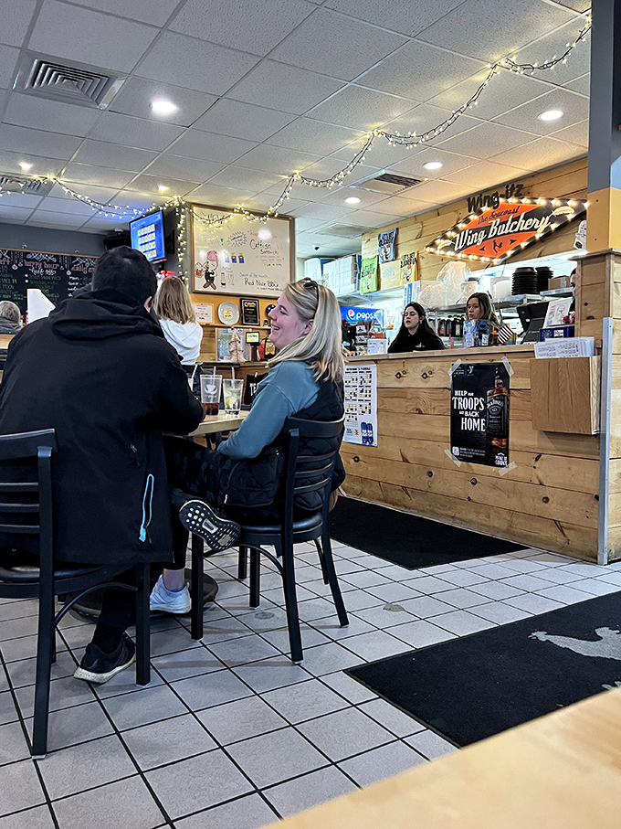 Happy customers in their natural habitat: surrounded by good food and even better company. Wing-itz: where strangers become sauce-covered friends.