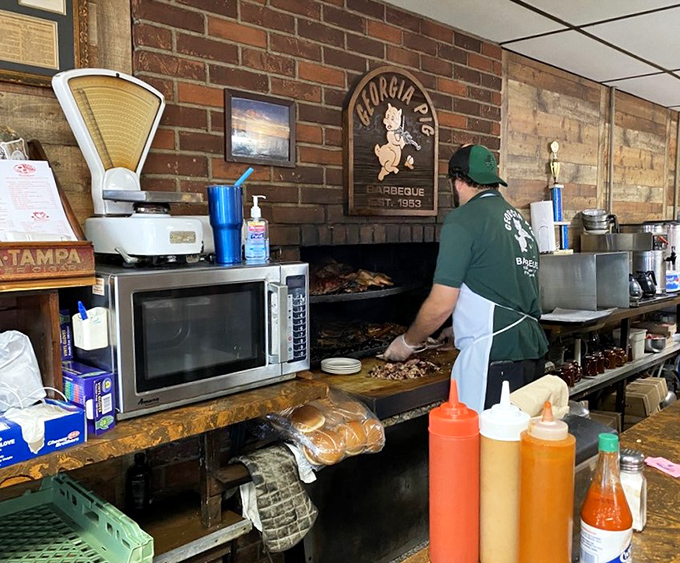Where the magic happens! This pitmaster's skilled hands are like the barbecue equivalent of a conductor's baton, orchestrating smoky symphonies.