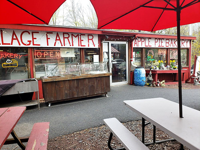 Red umbrellas and rustic charm - this entrance is basically saying, "Come on in, the pie's fine!"