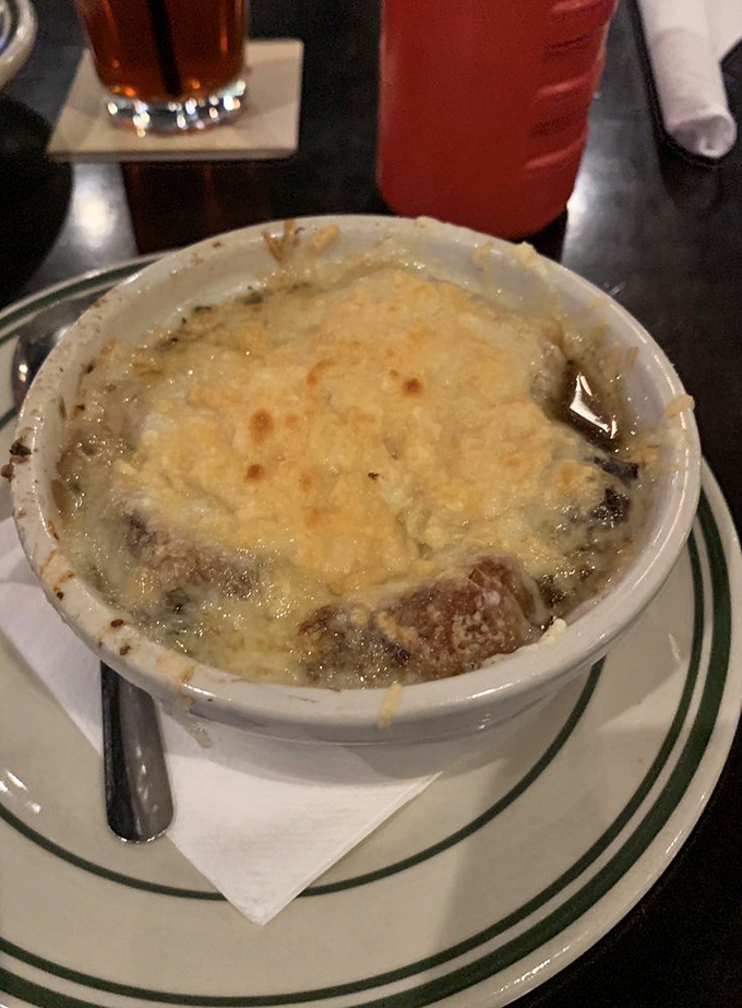 French Onion Soup: a cheesy lid concealing a savory secret. It's like opening a delicious present, only you get to eat it afterward.