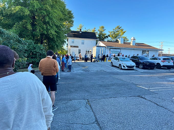 The line of pilgrims to the donut promised land! Some quests are worth the wait, and this one promises sugary salvation.