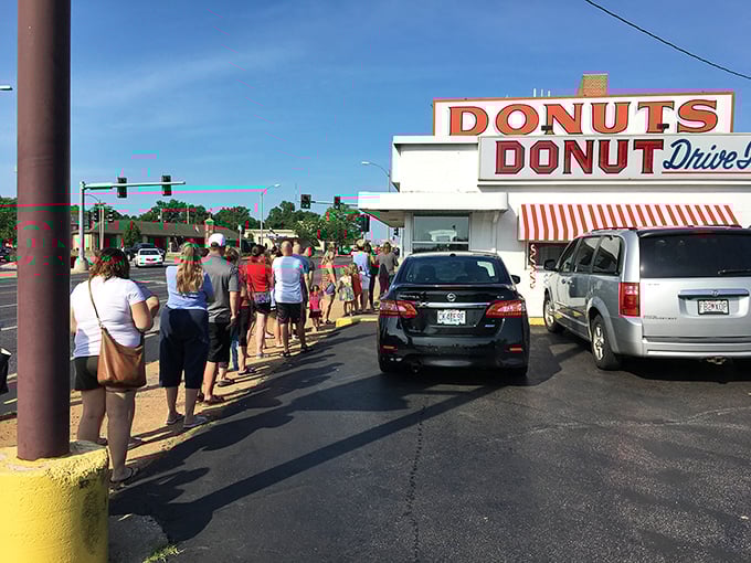 The line of anticipation! These folks aren't just waiting; they're on a pilgrimage to the promised land of fried dough.