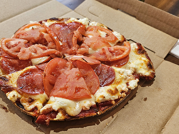 Tomato, tomahto, let's call the whole thing delicious! This pizza's fresh slices add a juicy pop to every bite. It's like summer decided to crash a cheese party.