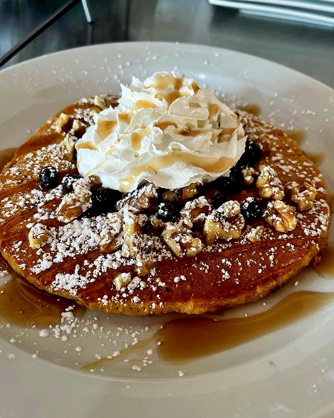Pumpkin pancakes that could make Jack-o'-lanterns jealous. Topped with a cloud of whipped cream, it's like autumn decided to hug your taste buds.