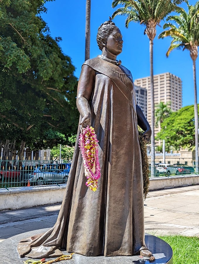 Queen Lili'uokalani stands tall, a reminder of Hawaii's royal past amidst modern Honolulu's hustle.