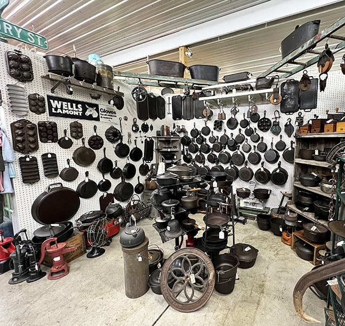 Cast iron paradise! This wall of seasoned skillets and pots holds the secret to perfectly crispy cornbread and mouth-watering cobblers.