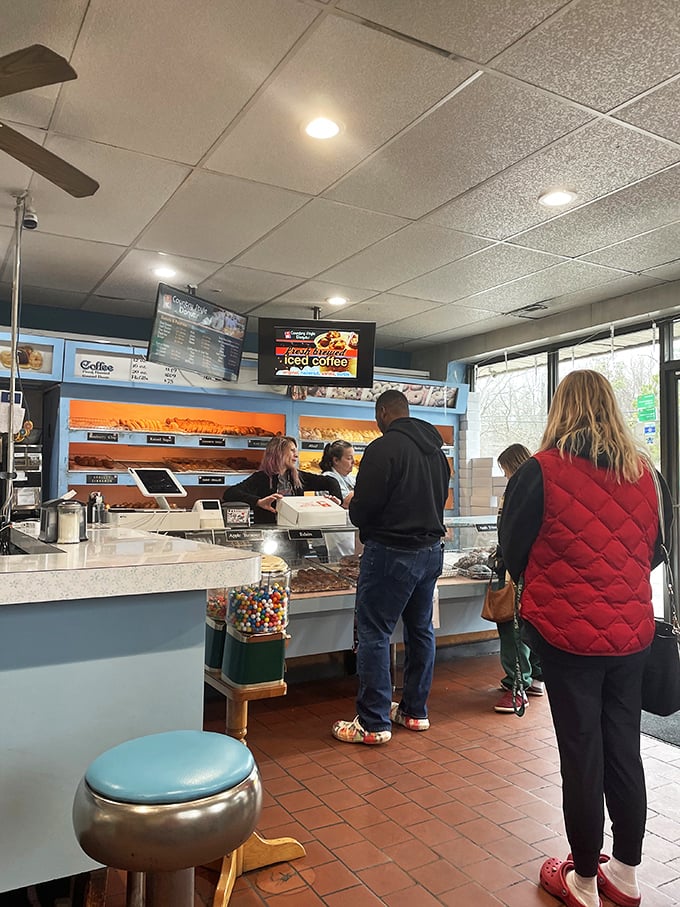 The universal language of donut anticipation. People from all walks of life united by the promise of freshly fried dough and friendly service.