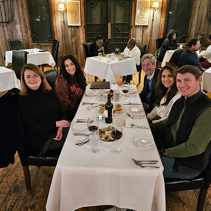 Happy diners, great food, and warm smiles &ndash; it's the holy trinity of a perfect night out. This table's joy is more contagious than a yawn in a boring meeting.