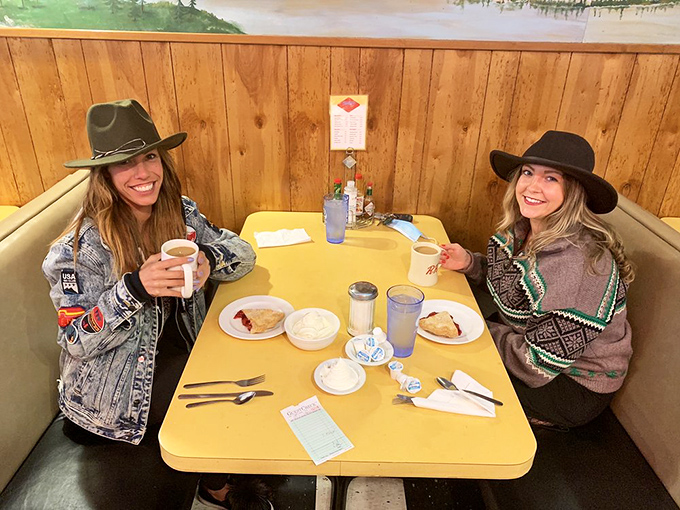 Two happy campers living their best diner life! These gals know the secret to a perfect day: good food, great company, and hats that mean business.