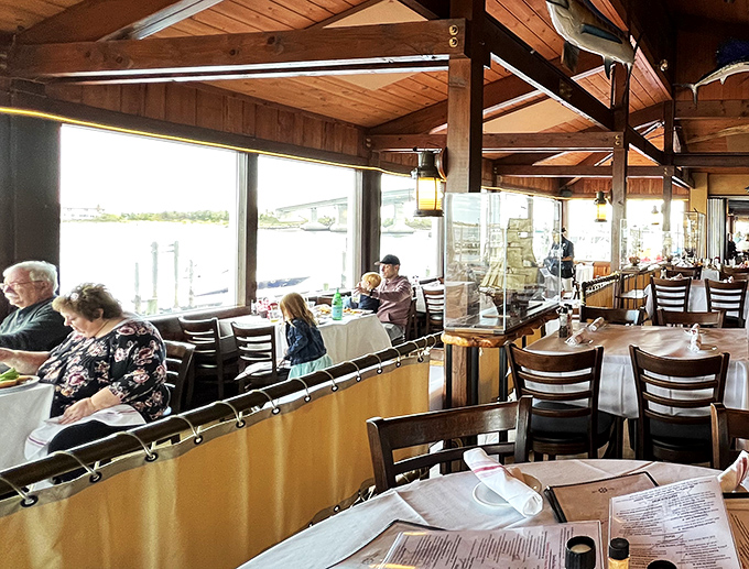 Happy diners soaking up the views and the chowder. It's like a Norman Rockwell painting, but with more tartar sauce.