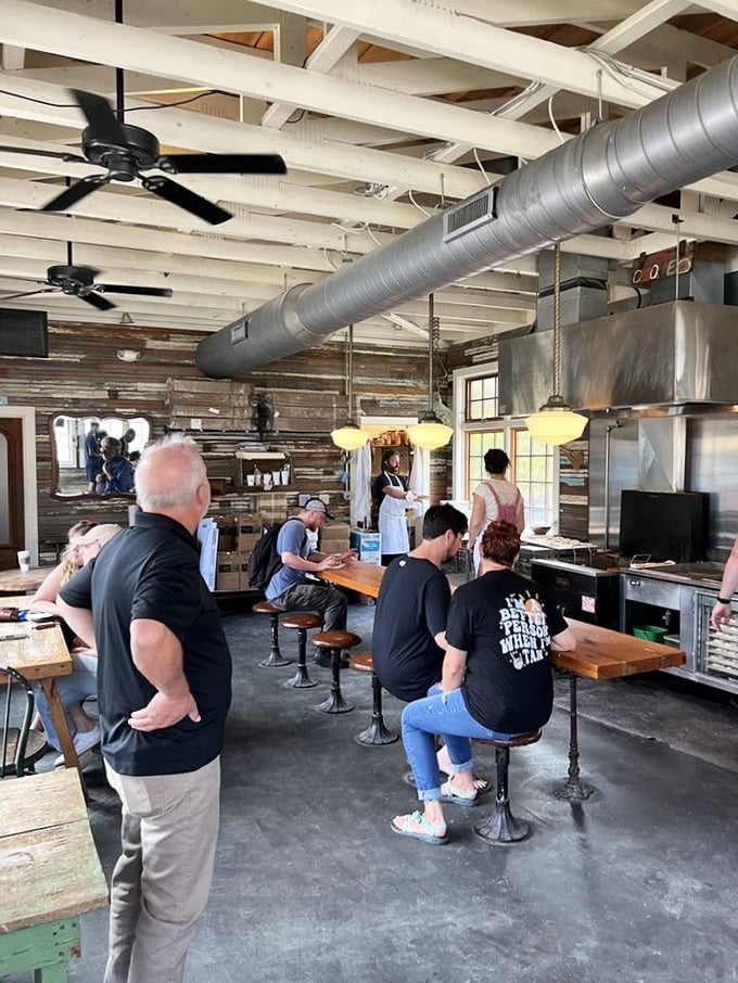 Doughnut devotees in their natural habitat! These lucky diners are living their best lives, one bite at a time. It's like watching a nature documentary, but with more sugar and less David Attenborough.