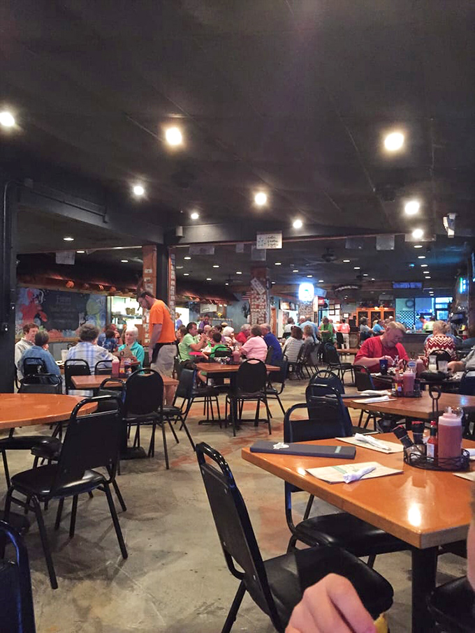 Full house alert! This bustling dining room is proof that good food brings people together faster than you can say "Pass the hushpuppies!"
