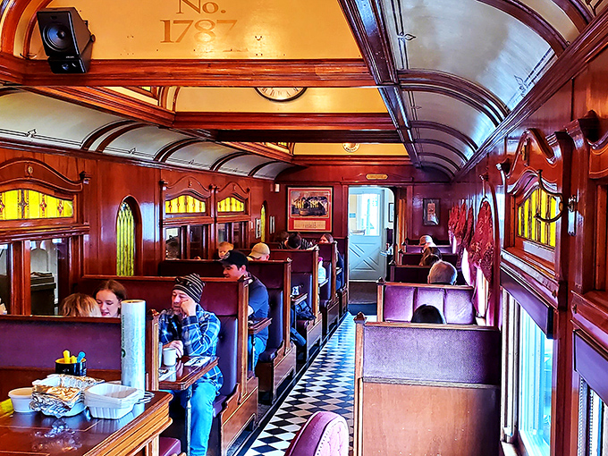 Happy diners in their natural habitat. Proof that good food and cozy booths are the secret ingredients to pure joy.