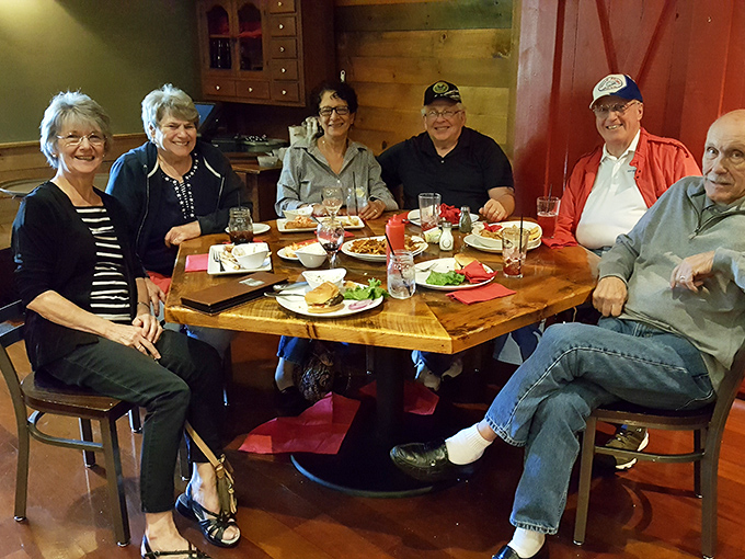 Happiness looks like this: friends gathered around a wooden table, halfway through what will become legendary stories of "that amazing meal."