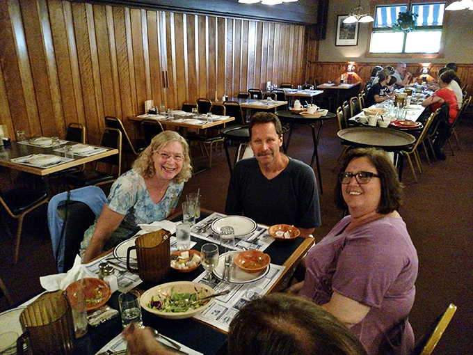 Happy diners, full bellies! These folks look like they've just discovered the secret to eternal happiness - and it might be on their plates.