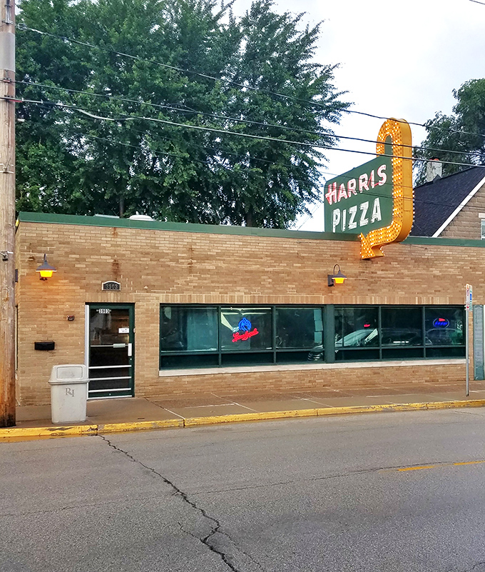 Harris Pizza: The OG of Quad Cities style. That retro sign isn't just illuminated &ndash; it's enlightened. Carry-out only? Challenge accepted!