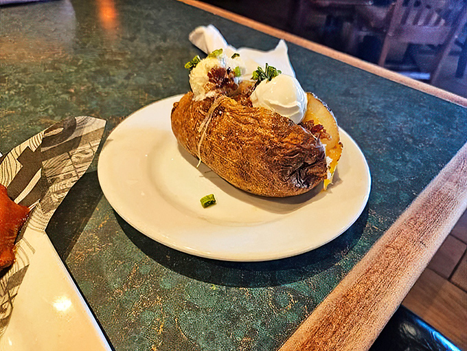 Is it a baked potato or a work of art? At Smokey Bones, it's both. This spud's got more toppings than your grandma's got stories.