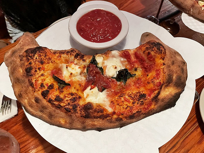 Behold the calzone, pizza's mysterious cousin! It's like a delicious secret wrapped in a warm, doughy hug.