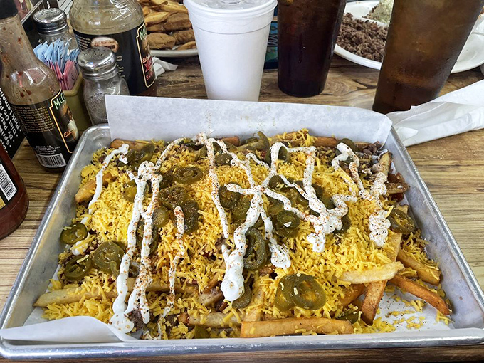 Loaded fries that laugh in the face of moderation. That river of white sauce and those jalapeños mean business—delicious, delicious business.