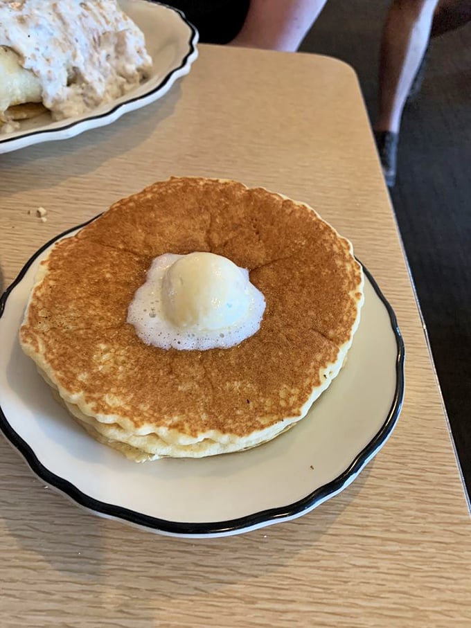 A pancake so fluffy, it might float away if not for that generous pat of butter. Quick, catch it with your fork!