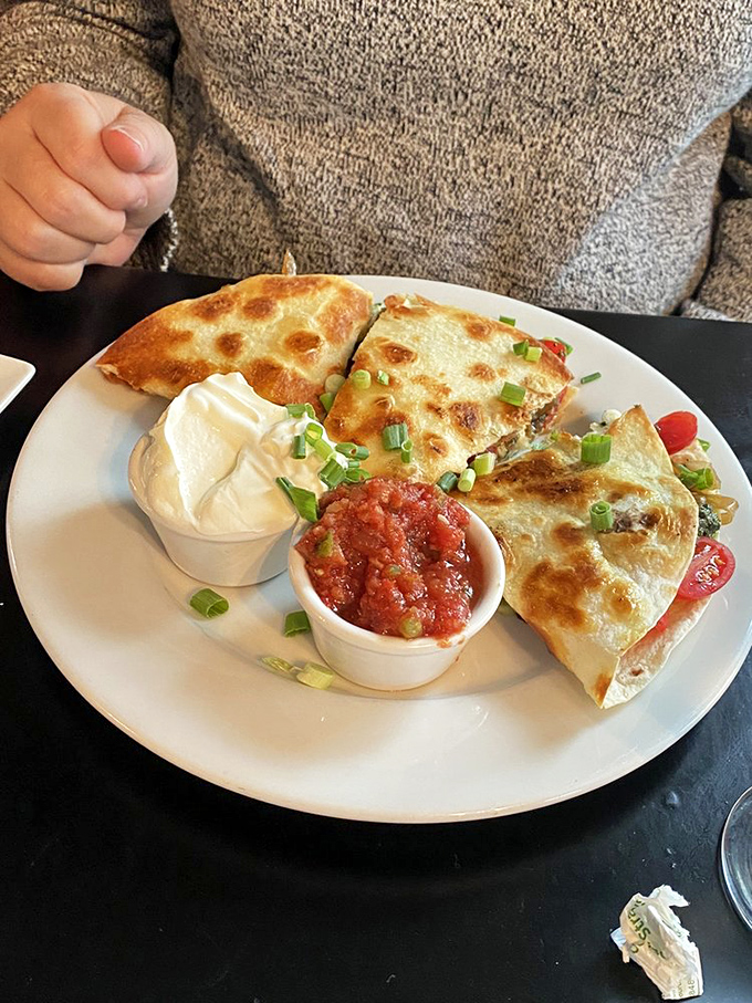 Quesadilla or work of art? This cheesy masterpiece, adorned with fresh toppings, is a fiesta for your taste buds.