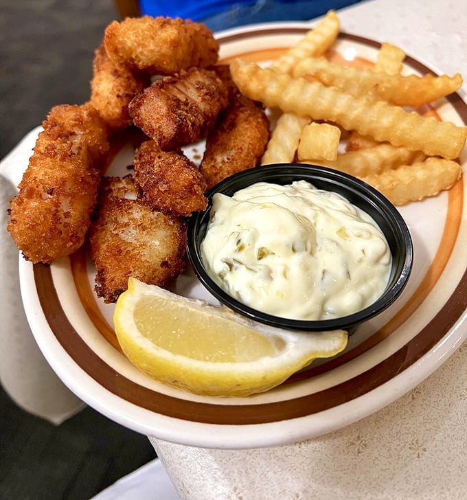 Golden-fried walleye bites with that perfect crunch-to-tenderness ratio. The tartar sauce isn't just a condiment&mdash;it's a perfect partner.