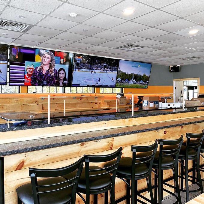 The bar area: where sports fans and wing enthusiasts unite. It's like Cheers, but with more napkins and finger-licking goodness.