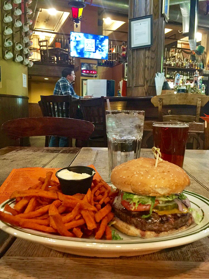 Burger bliss achieved! This juicy masterpiece, flanked by crispy sweet potato fries, is the stuff of fast-food daydreams.