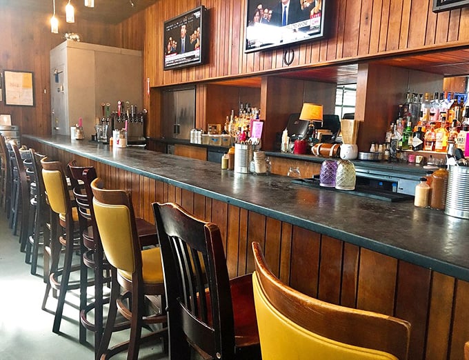 The bar's mismatched wooden chairs in cheerful yellow punctuate the serious business of cocktail crafting happening behind that well-worn counter.