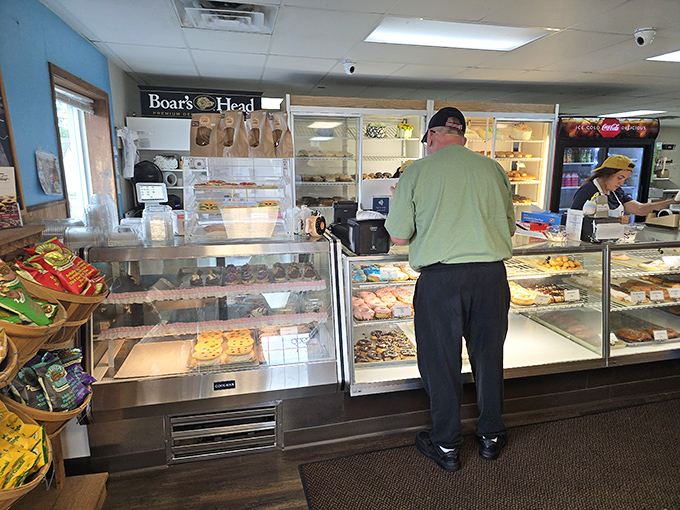 Behind the counter, where the magic happens. It's like peeking behind the curtain at Oz, but instead of a wizard, you find donut wizardry.