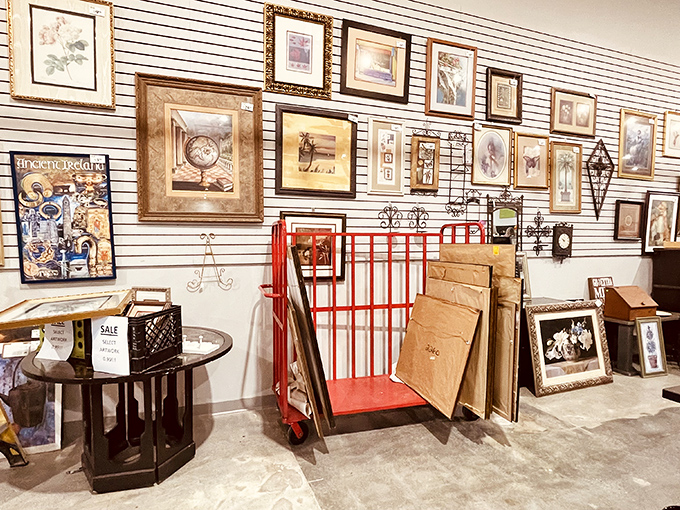 The art wall transforms the warehouse into an impromptu gallery, where forgotten masterpieces and quirky prints find new admirers daily.