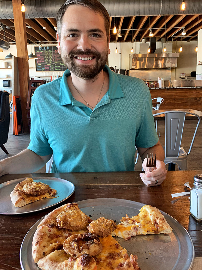 Pizza and smiles: a match made in heaven. This diner's grin is proof that Hardware Pizza serves up happiness by the slice.