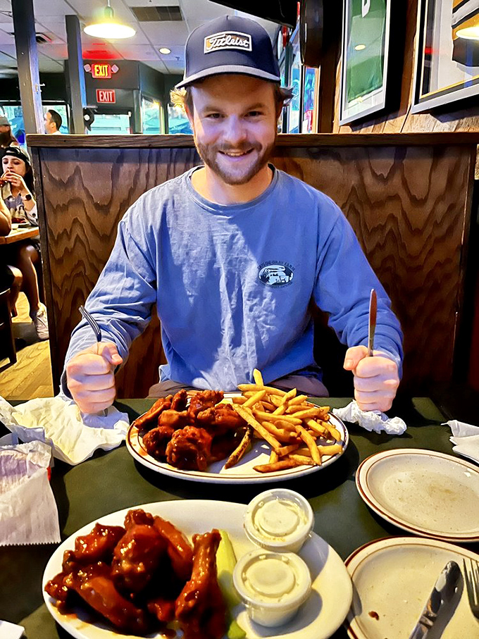 This diner's grin says it all: "I've found wing nirvana, and I'm never leaving." We feel you, buddy.