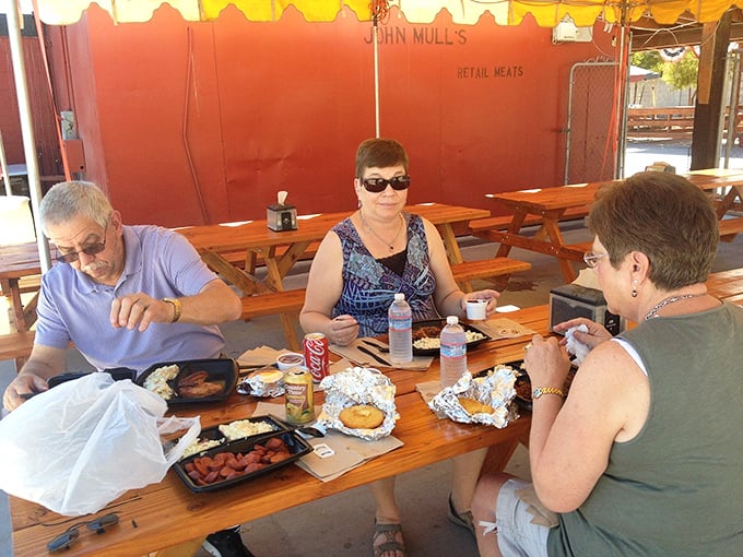 The universal language of barbecue brings people together at these picnic tables, where napkins are necessities, not accessories.