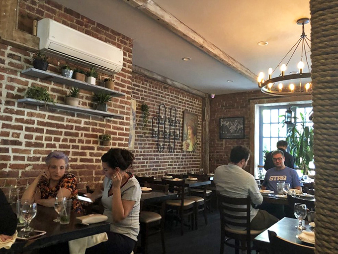 Happy diners, brick walls, and good vibes. At Reef, every meal feels like a party where the seafood is the guest of honor.
