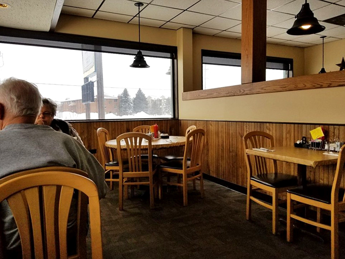 A sea of wooden chairs and tables, each with a front-row seat to breakfast theater. Watch as plates of steaming goodness make their grand entrance, starring in "The Hunger Games: Diner Edition."