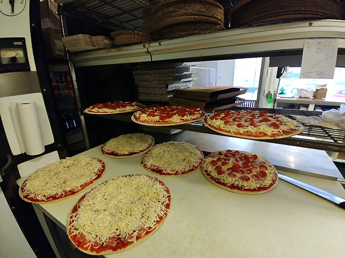 Pizza production line perfection! Watching these pies come to life is like seeing the Italian version of Santa's workshop. Elves not included.