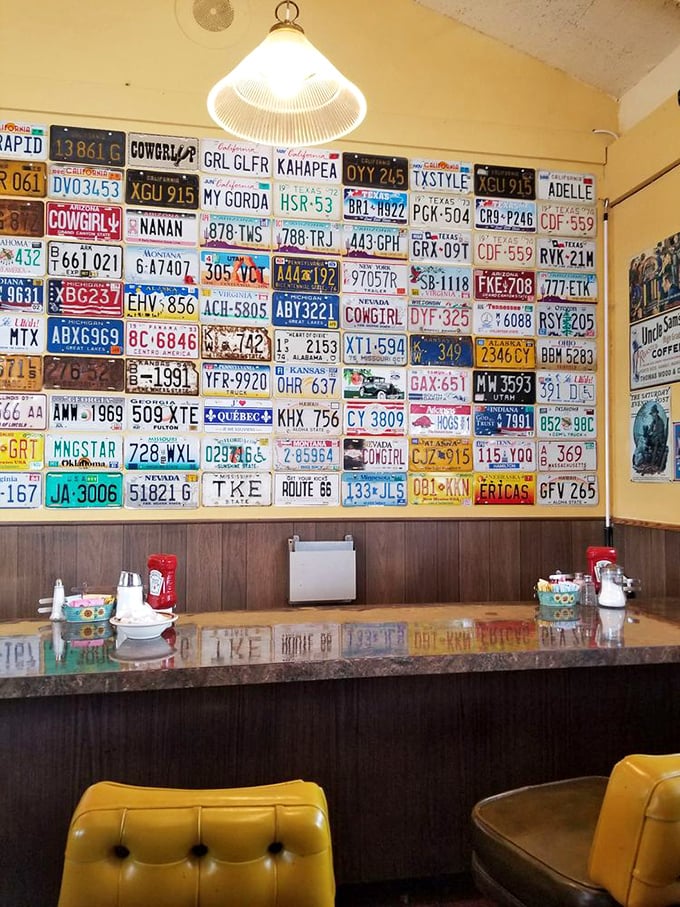 License plate wall: a road trip down memory lane! Each plate tells a story, much like the satisfied customers who've dined here.