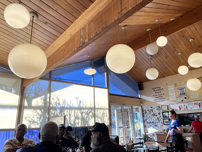 Wooden ceiling beams and globe lights create the perfect breakfast ambiance. Like dining in a cozy treehouse built specifically for pancake enthusiasts.