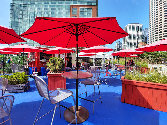 Red umbrellas, blue floors, and seafood galore! This patio is giving major coastal vibes in the heart of the city.